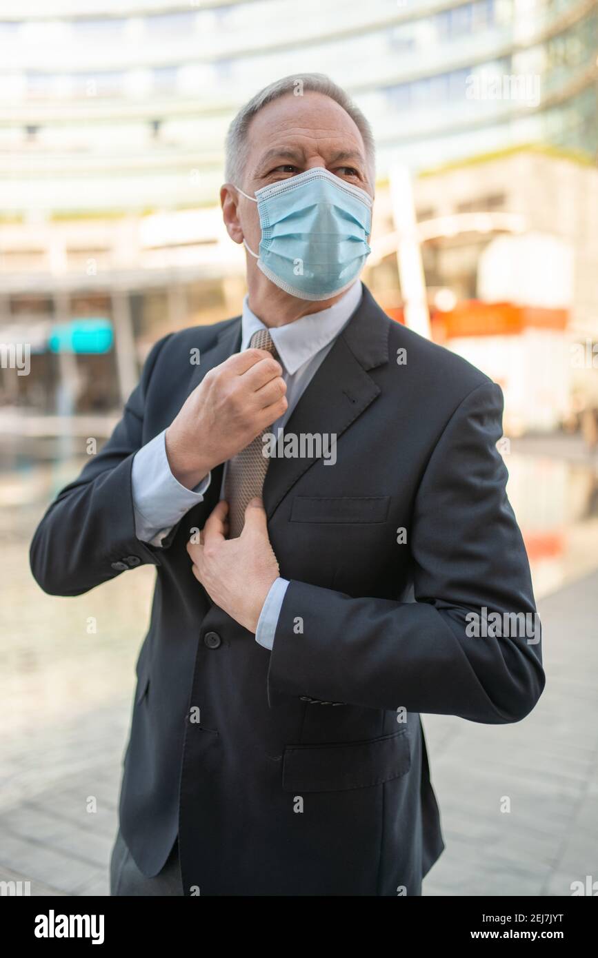 Portrait of a covid coronavirus masked businessman, management concept ...