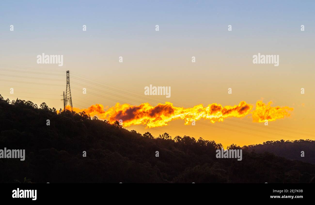Beautiful shot of sunset over greenery-covered hills Stock Photo - Alamy