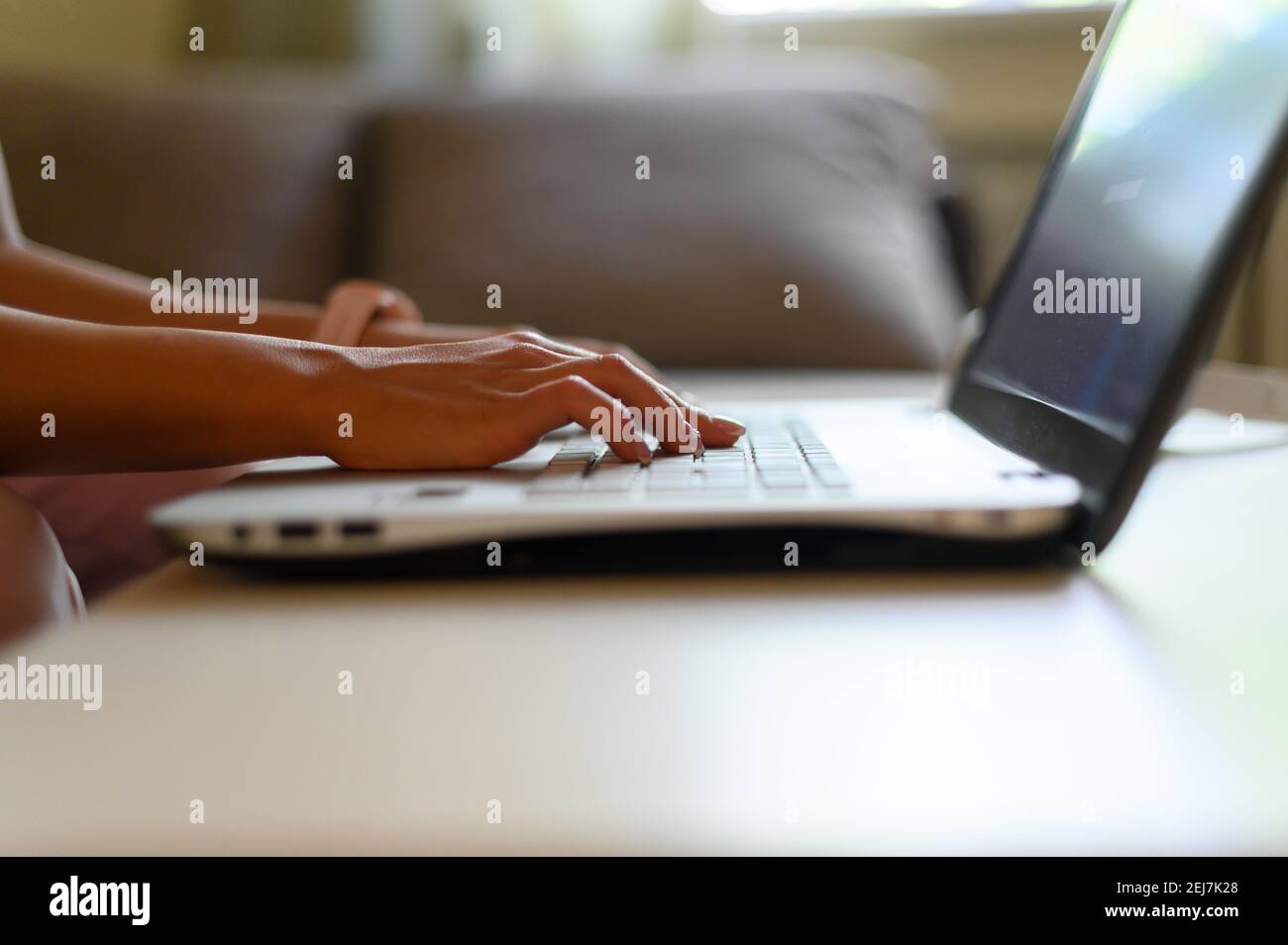 Closeup of a woman typing on a laptop keyboard Stock Photo - Alamy