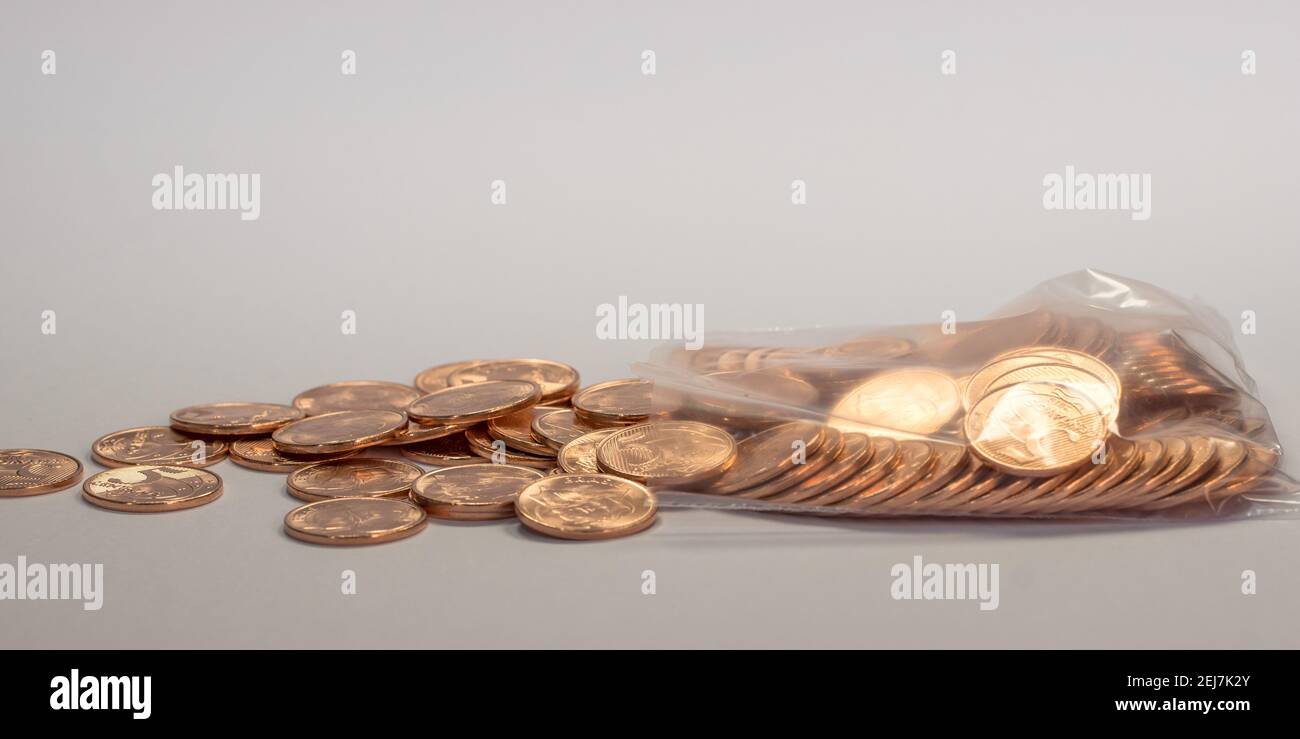 Pile of Brazilian real coins in a package isolated on a gray background ...