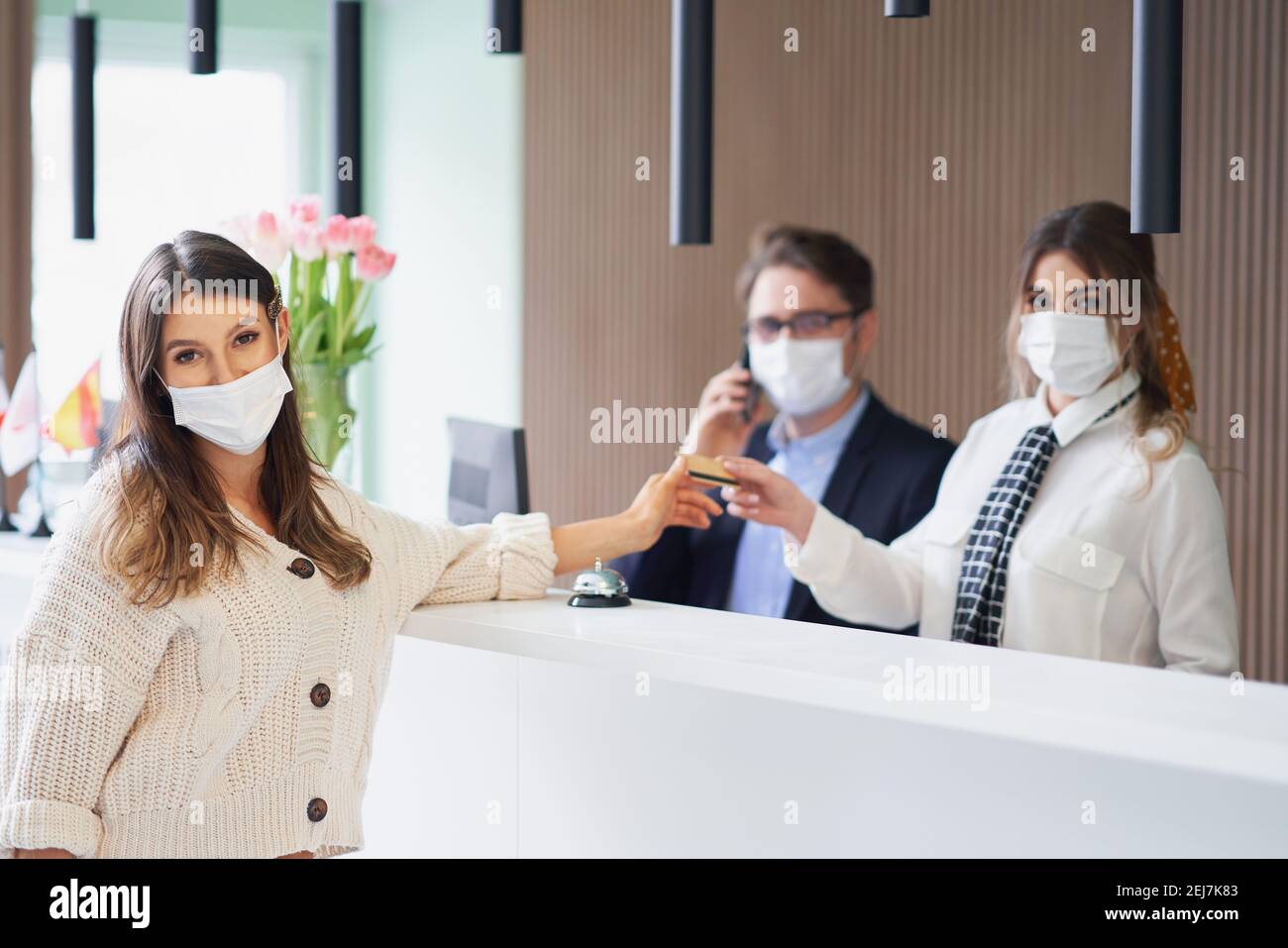 Female tourist waiting at reception desk in hotel Stock Photo - Alamy