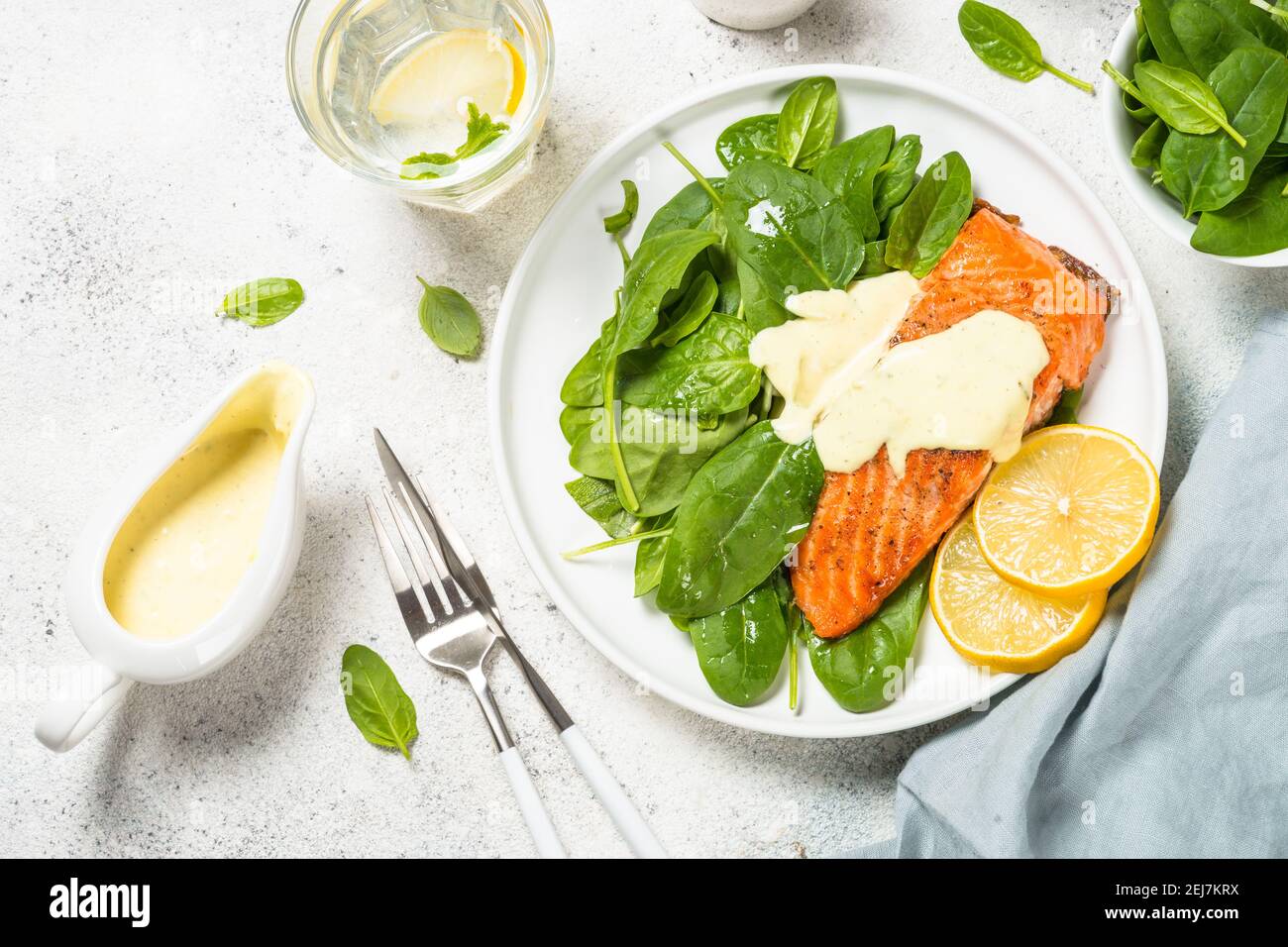 Salmon fillet with fresh salad and sauce at white Stock Photo - Alamy
