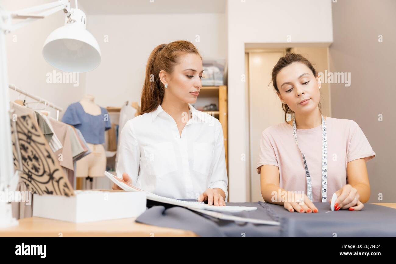 Student girl with teacher in dressmaking class, woman sewing lessons ...
