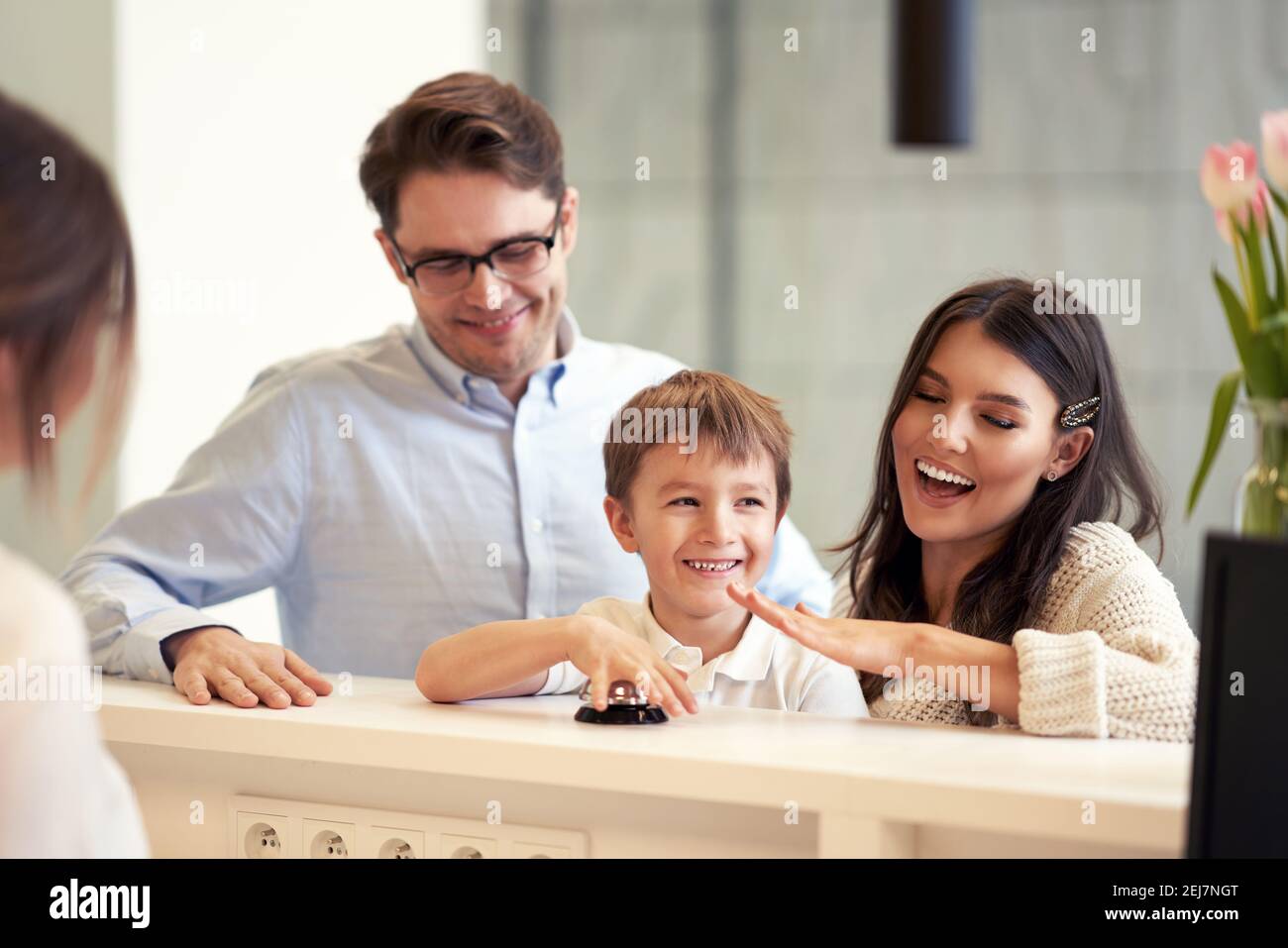 Picture of family checking in hotel Stock Photo - Alamy