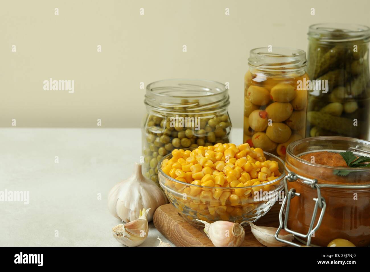 Different pickled food and ingredients on white textured table Stock ...