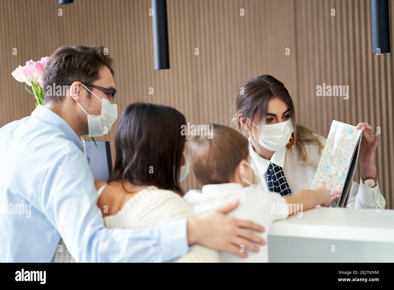Picture of family checking in hotel Stock Photo - Alamy
