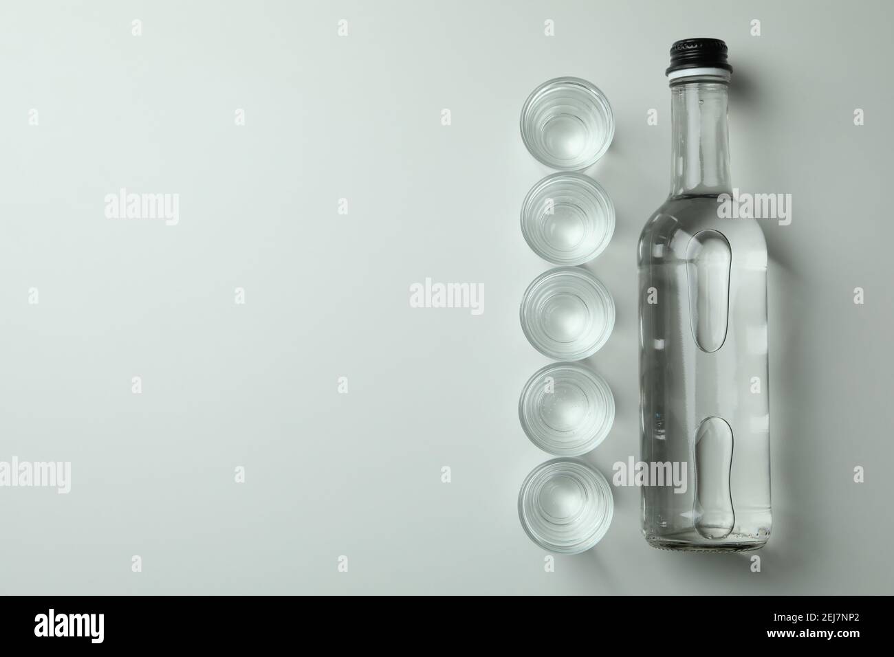 Bottle and shots of vodka on white background Stock Photo - Alamy