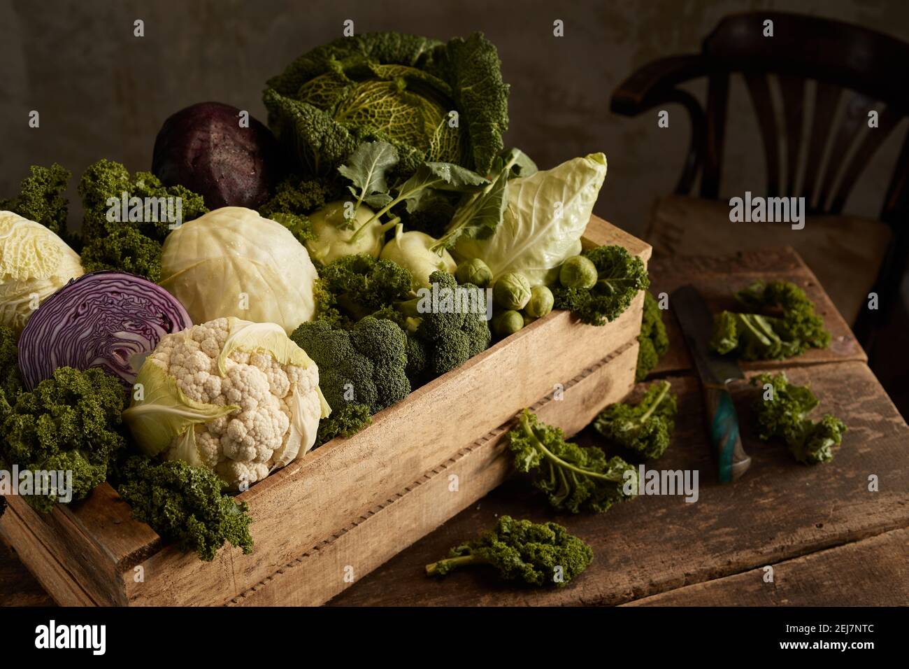 From above wooden box with assorted cabbaged placed on rustic lumber ...