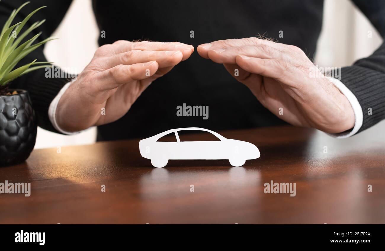 Insurer protecting a car with his hands Stock Photo - Alamy