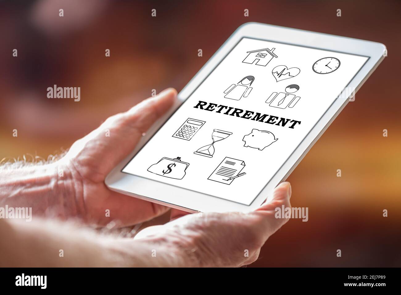 Man holding a tablet showing retirement concept Stock Photo - Alamy