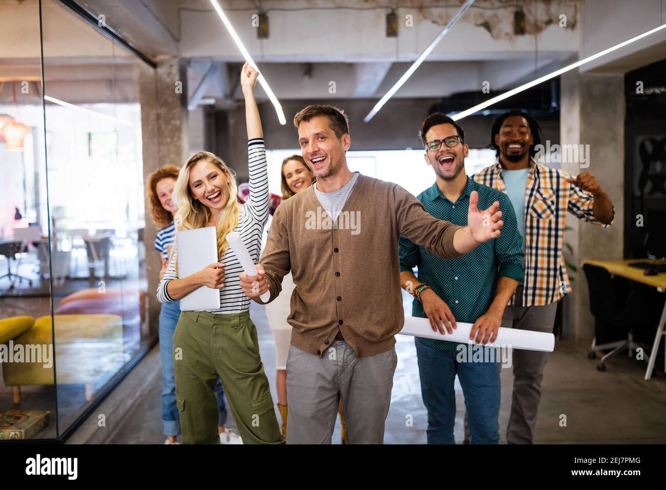 Happy business people celebrating success at company Stock Photo - Alamy