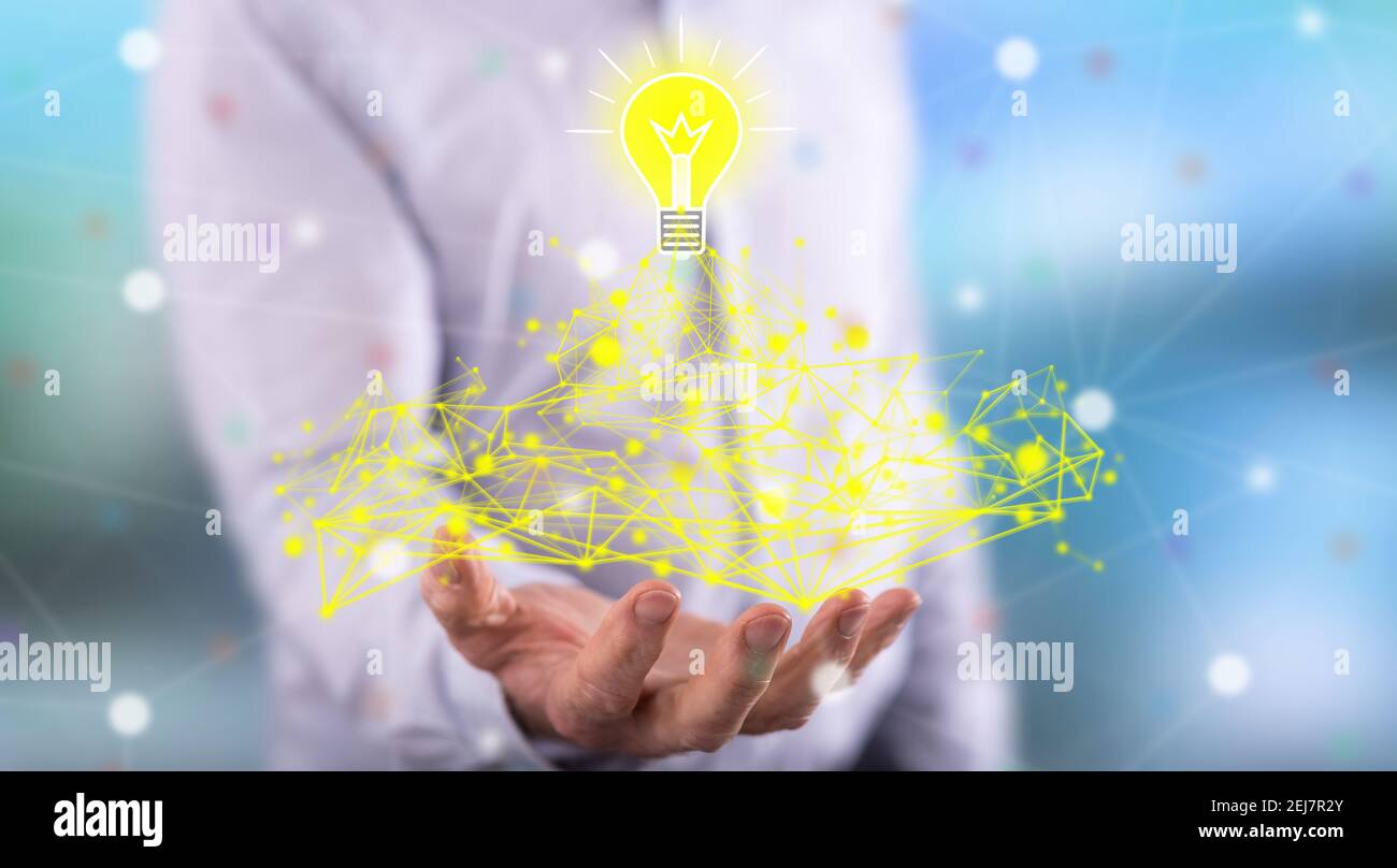Idea concept above the hand of a man in background Stock Photo - Alamy