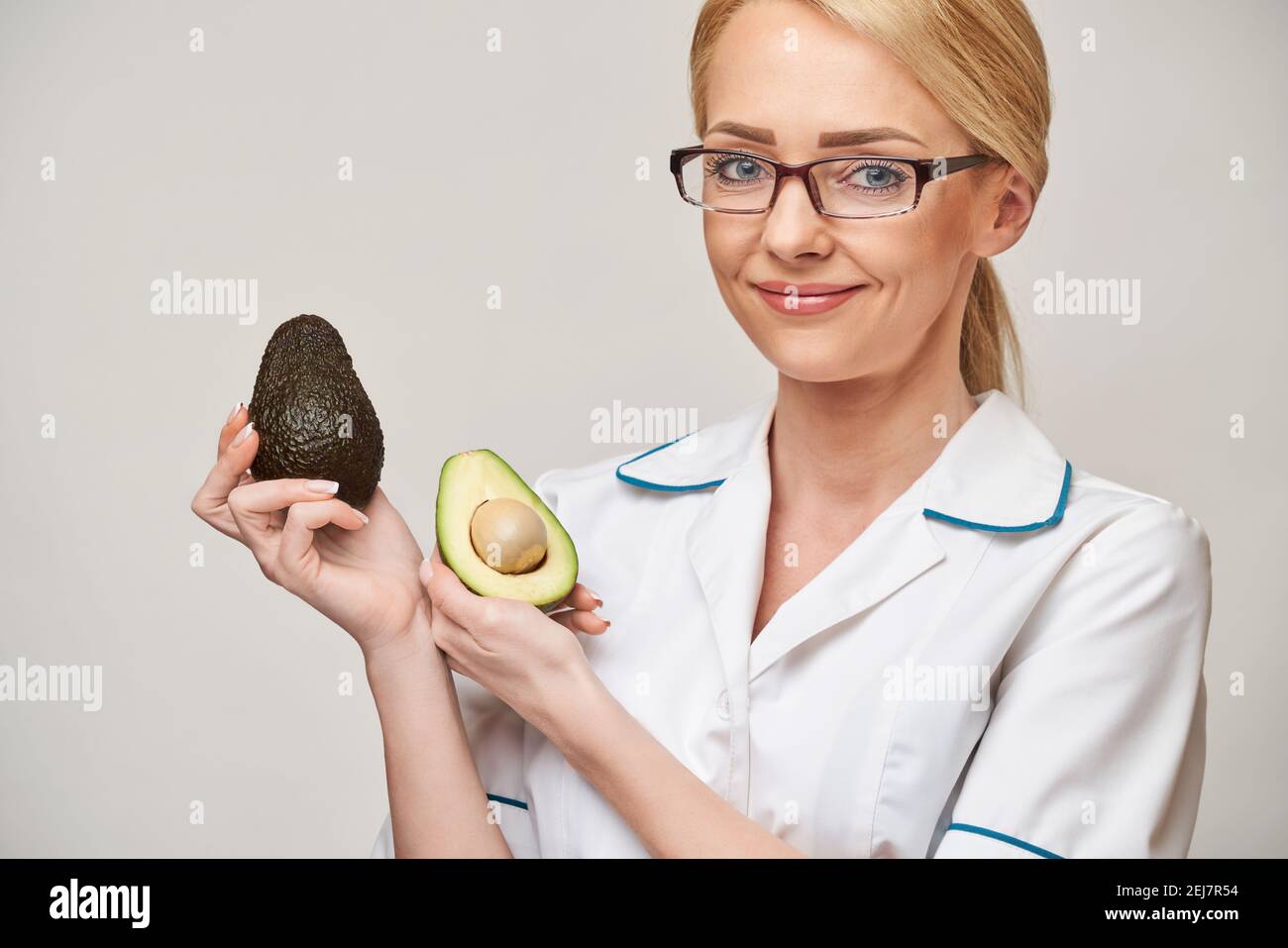 nutritionist doctor healthy lifestyle concept - holding organic avocado ...