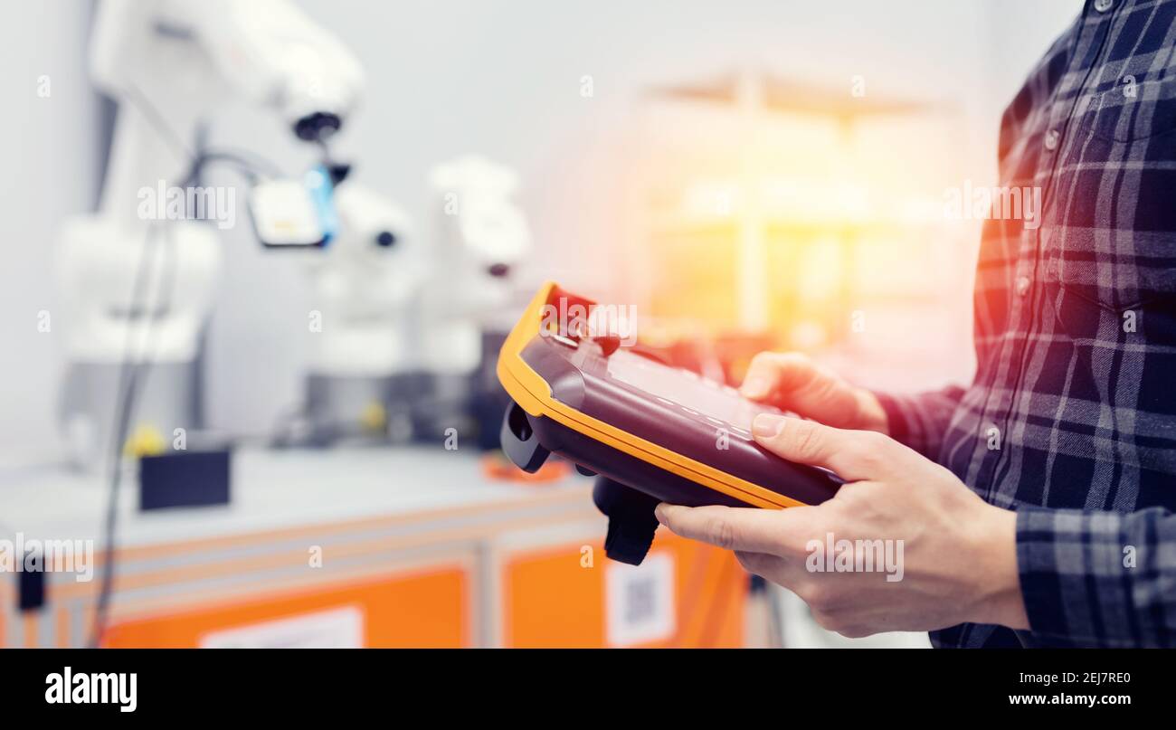 Engineer operator controls automatic mechanical robot arm to weld and ...