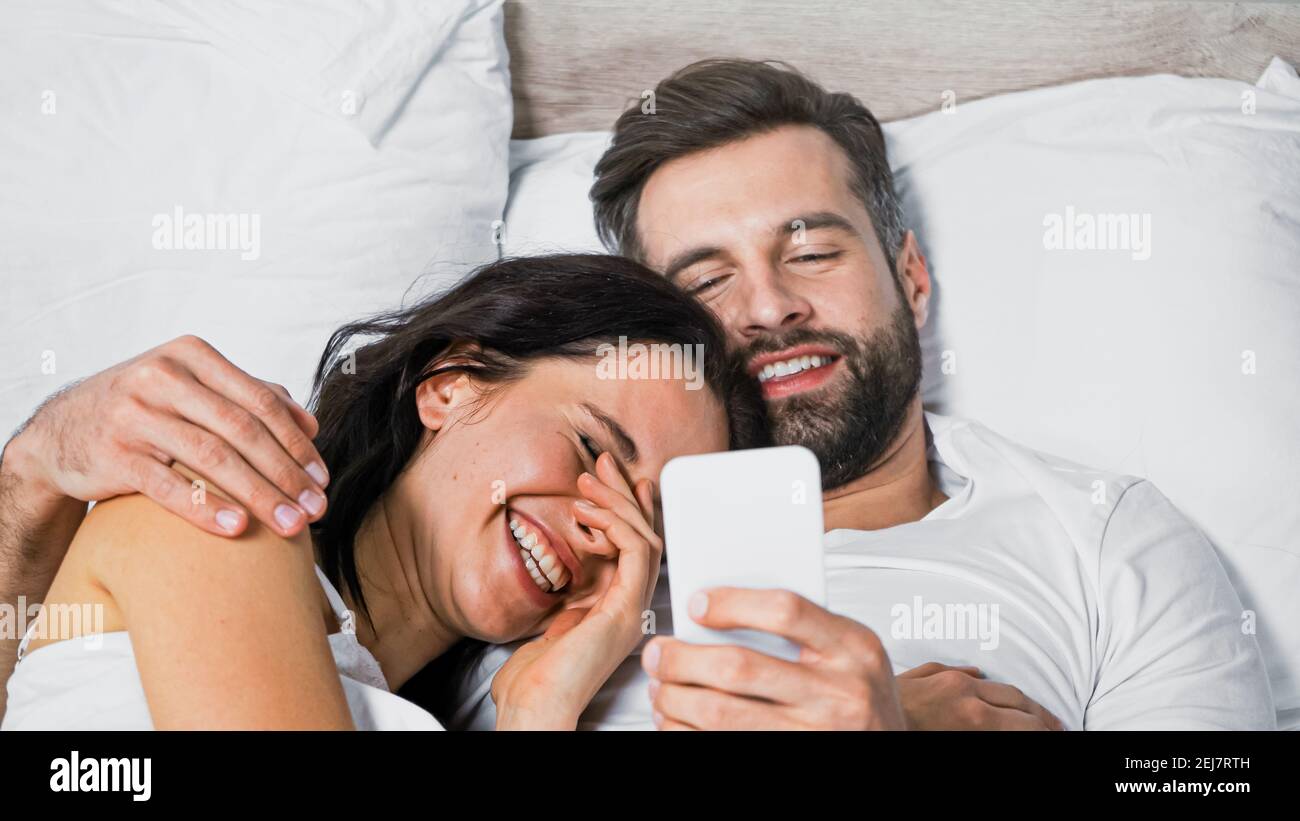 Excited woman lying in bed hi-res stock photography and images - Alamy