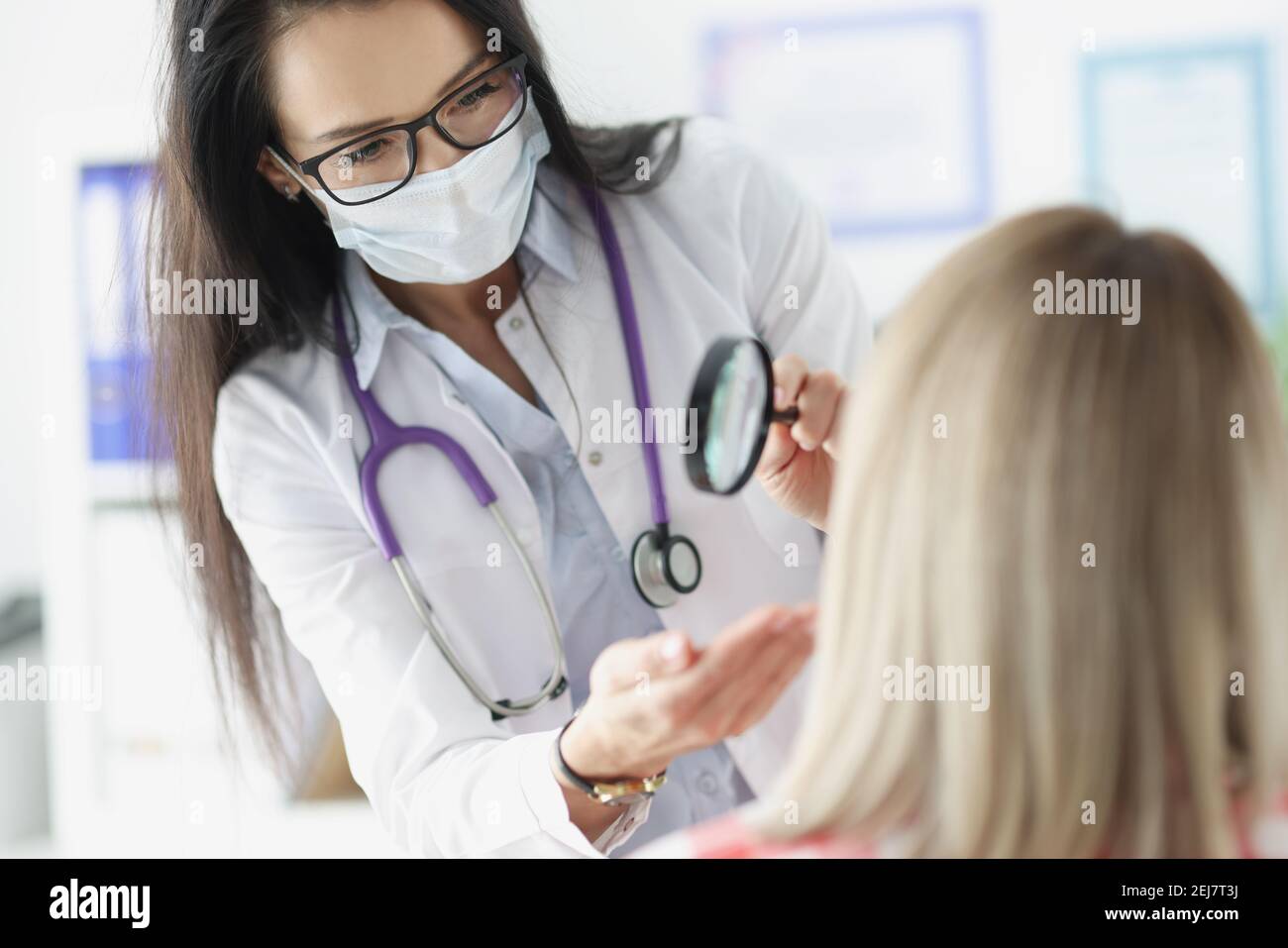 Doctor examining skin on patients face using magnifying glass Stock ...
