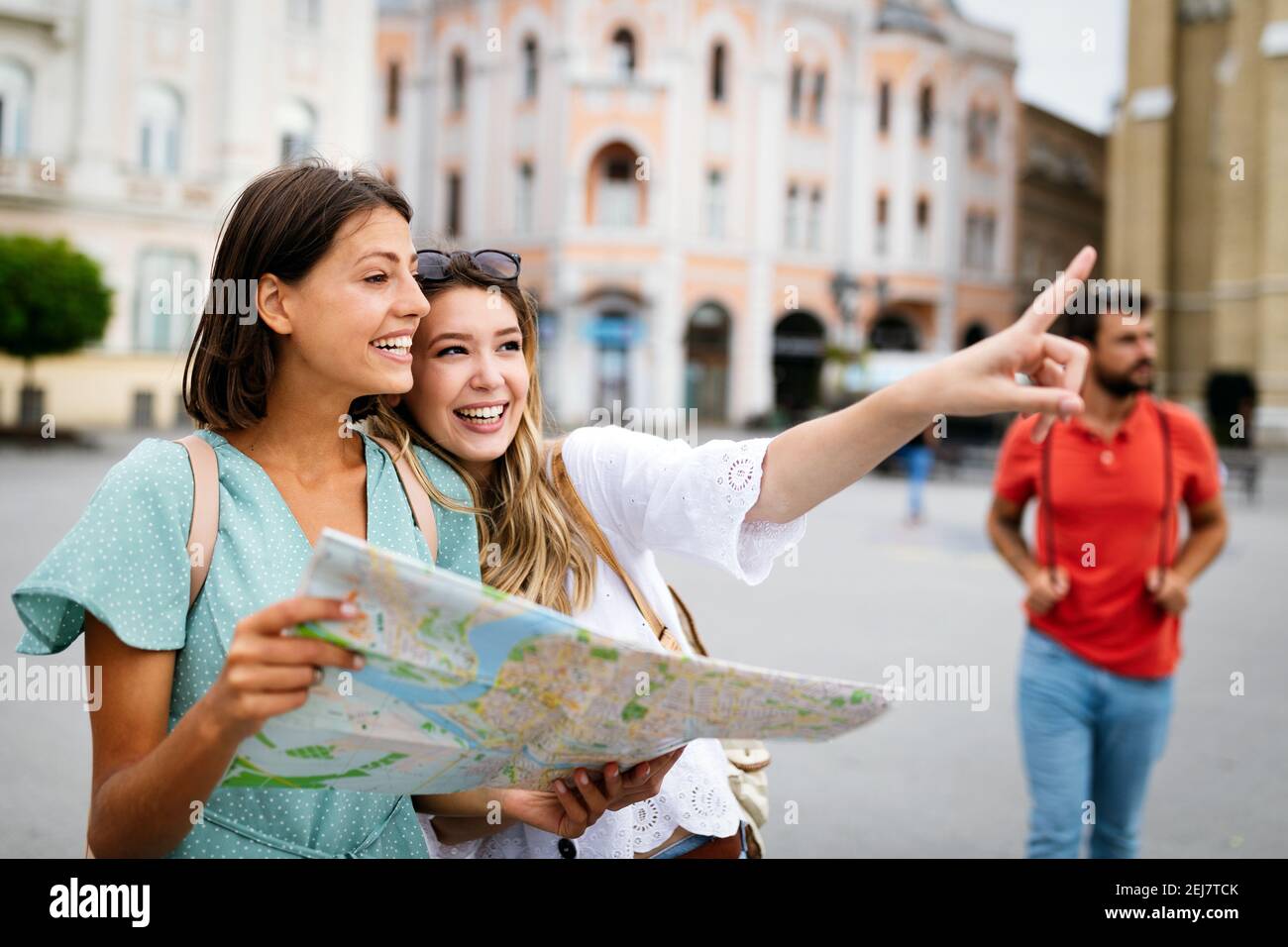 Happy friends enjoying sightseeing tour in the city Stock Photo - Alamy