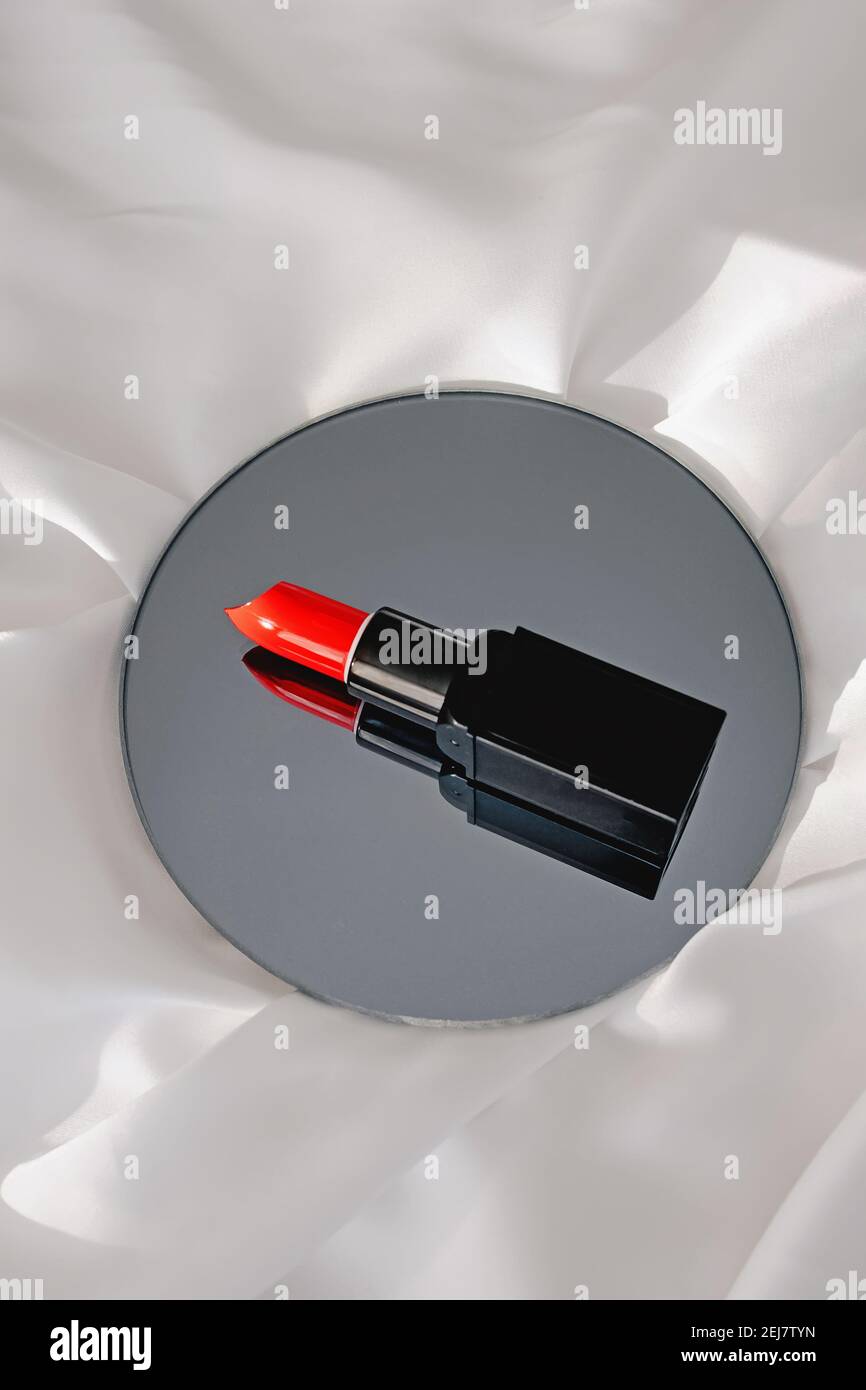 Red lipstick on a round mirror with reflection Stock Photo - Alamy
