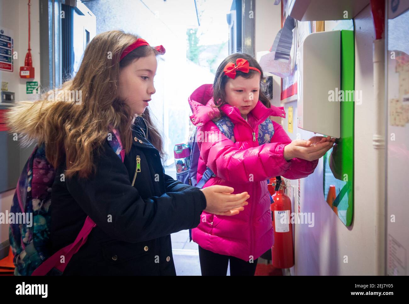 Pupils wash their hands as they arrive for their first day back at ...