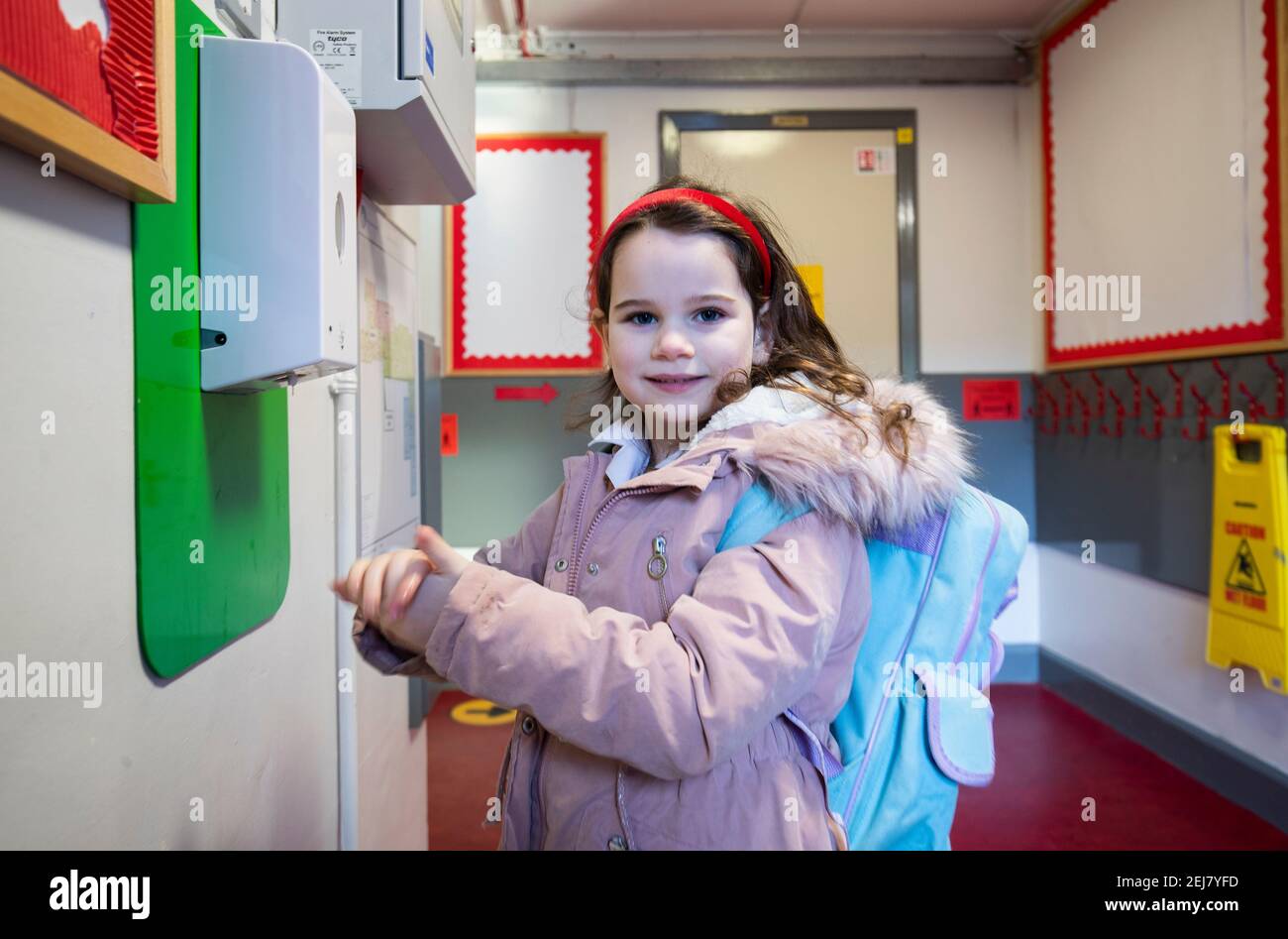 P2 pupil Aria Robertson, 6, washes her hands as she arrives for her ...