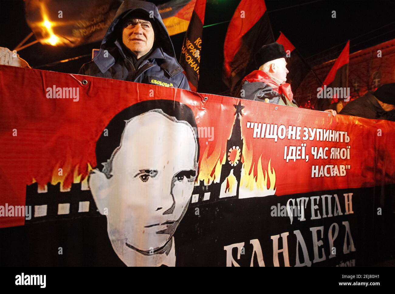 Ukrainian nationalists hold a banner with Stepan Bandera image during a ...