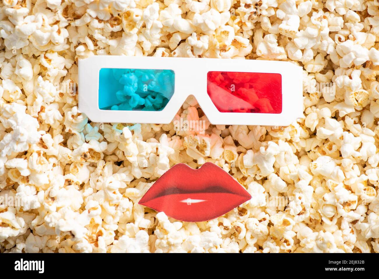 top view of 3d glasses near paper cut lips on tasty popcorn, cinema ...