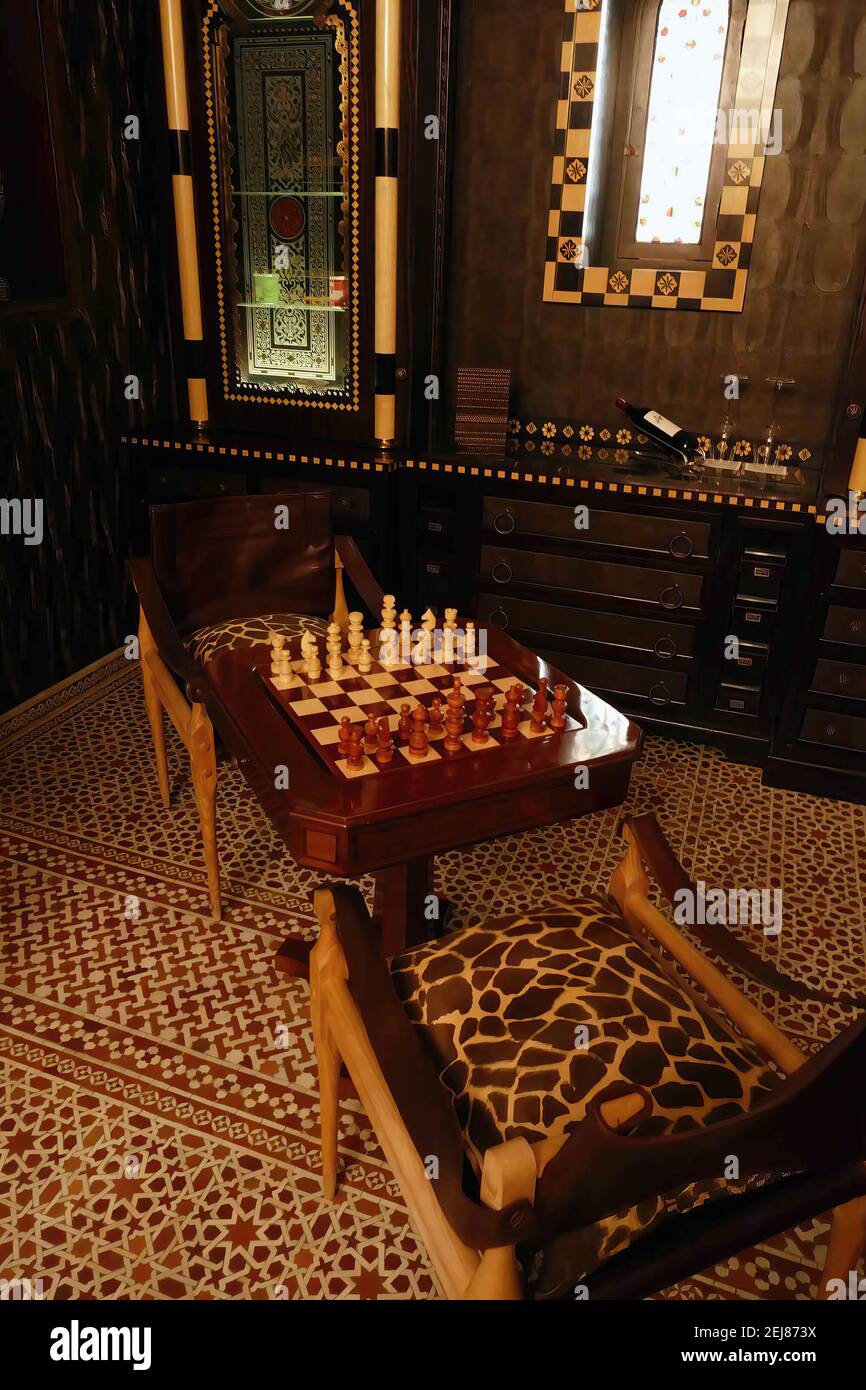 Vertical shot of a wooden chess table and chairs in a Moroccan style ...