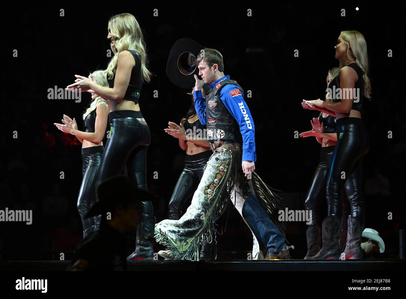 Bull riders take to the arena stage as they are introduced before the ...
