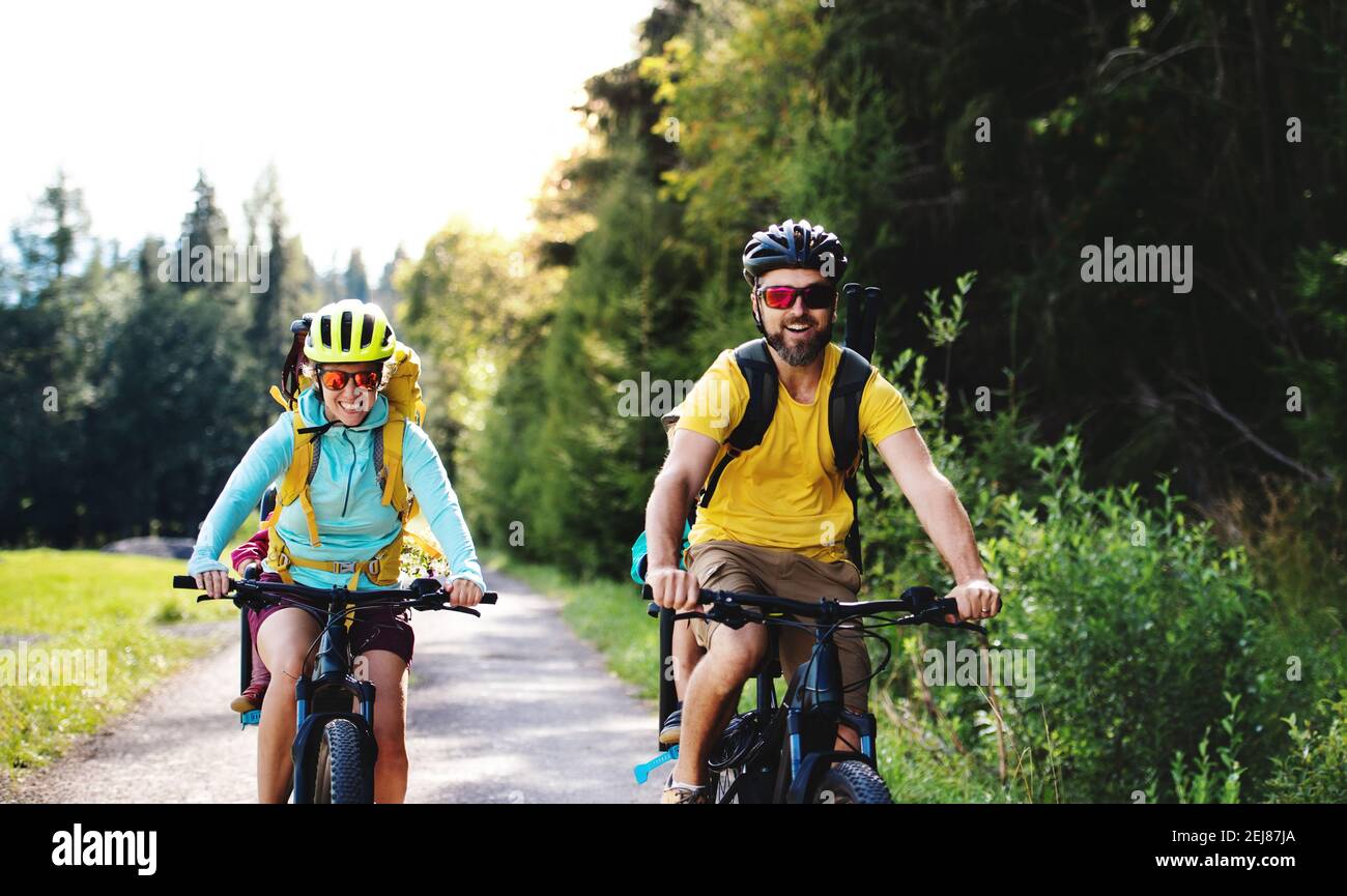 Family with small children cycling outdoors in summer nature Stock ...