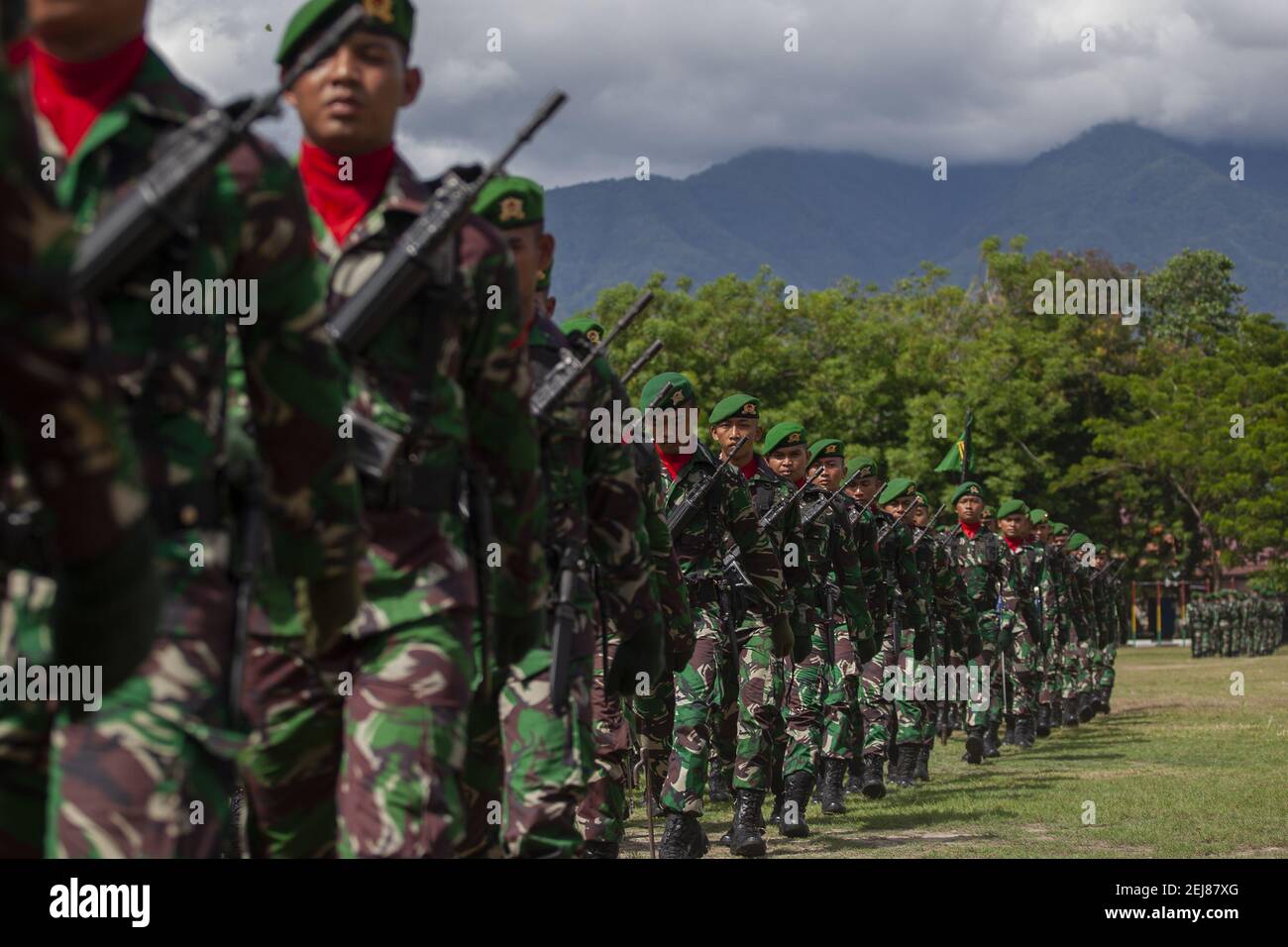 Soldiers stand on guard during the ceremony in Palu City. Soldiers of ...