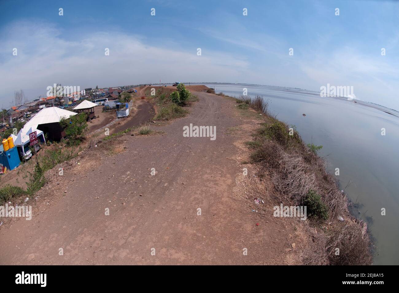 Levee surrounding mud lake disaster seperating village with mud lake ...