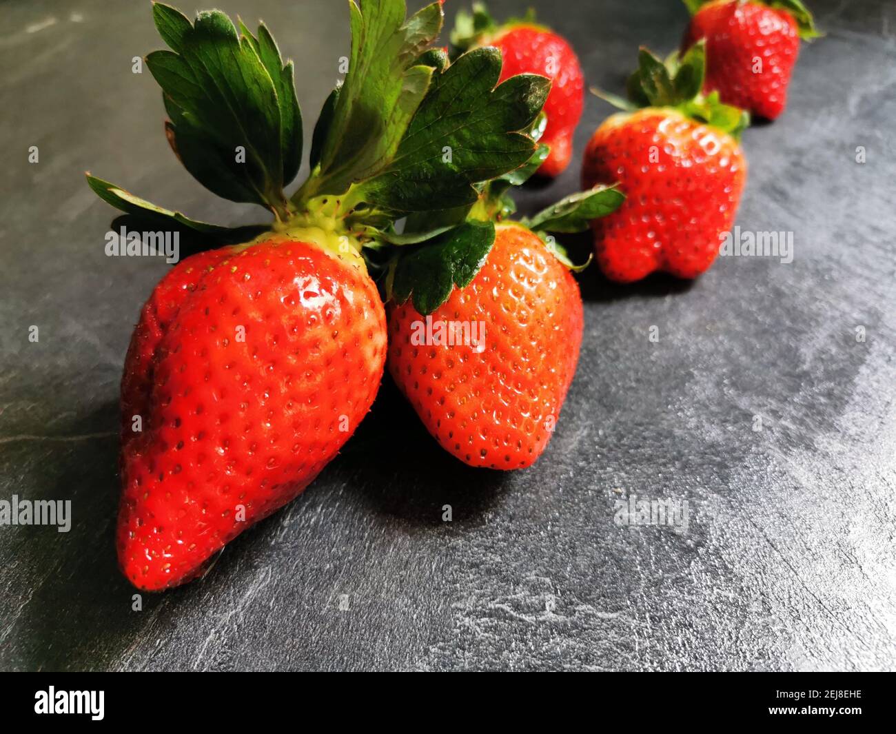 Set of strawberries on the kitchen bench Stock Photo - Alamy