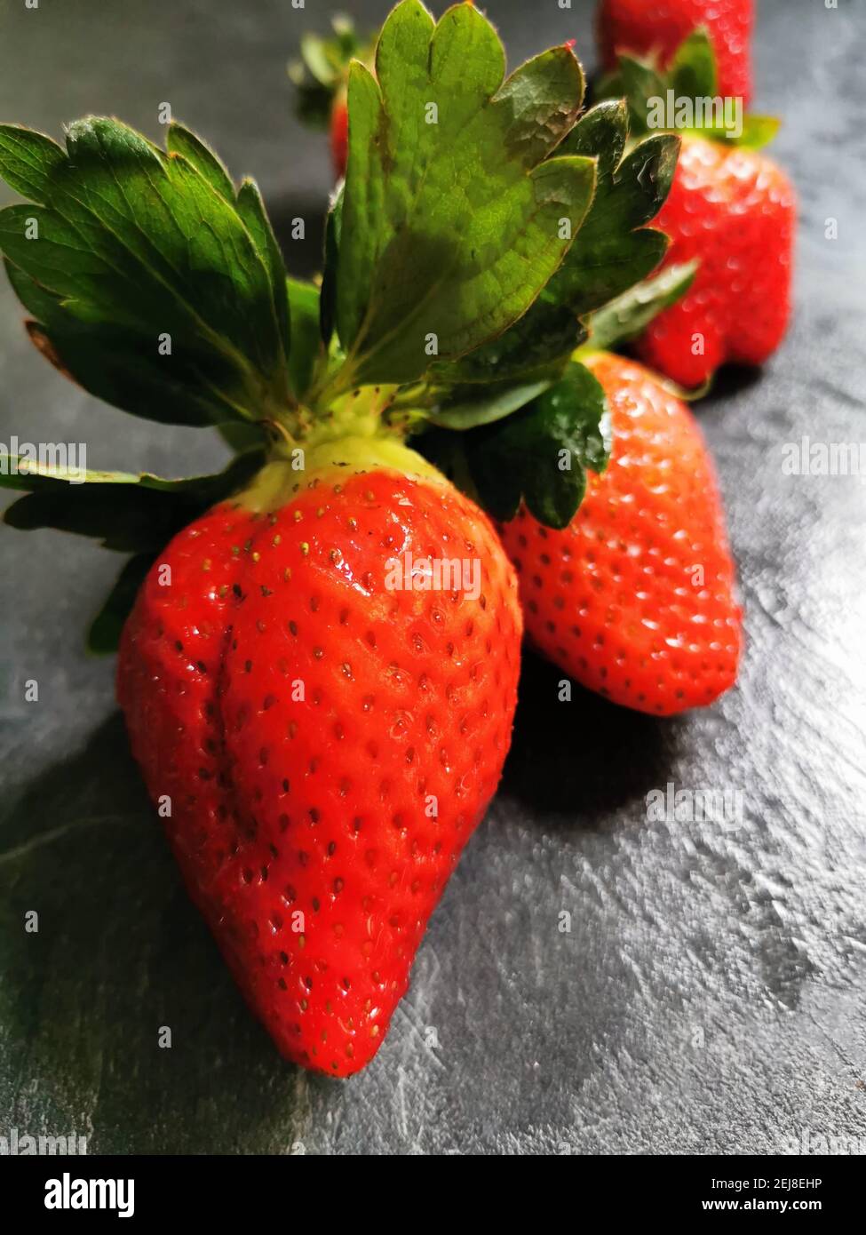 Set of strawberries on the kitchen bench Stock Photo - Alamy