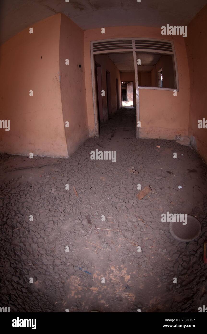 Abandoned house with dried mud on floor following flooding by mud lake ...