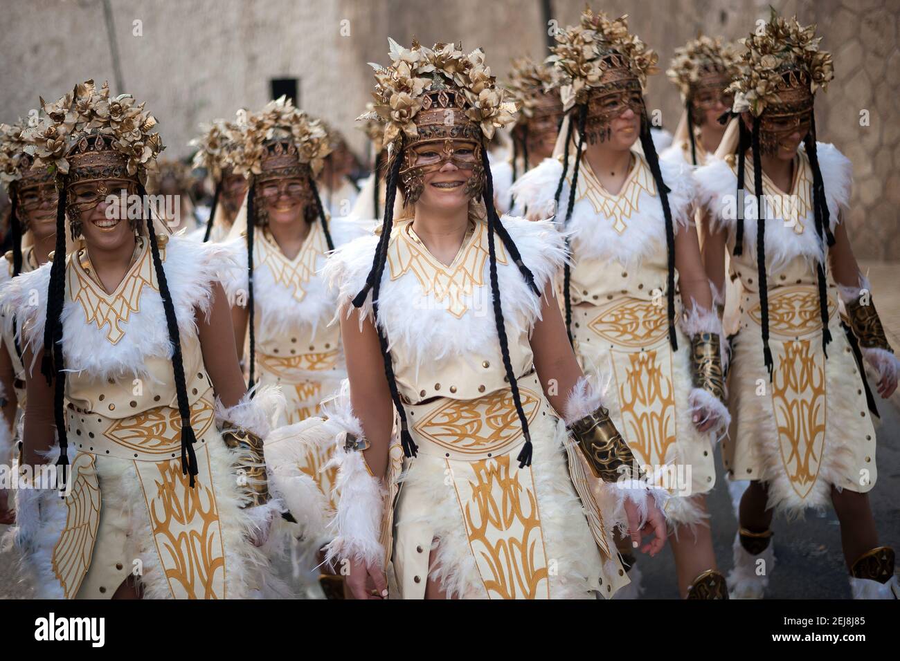Women dressed in fantasy costumes perform on the street during the ...
