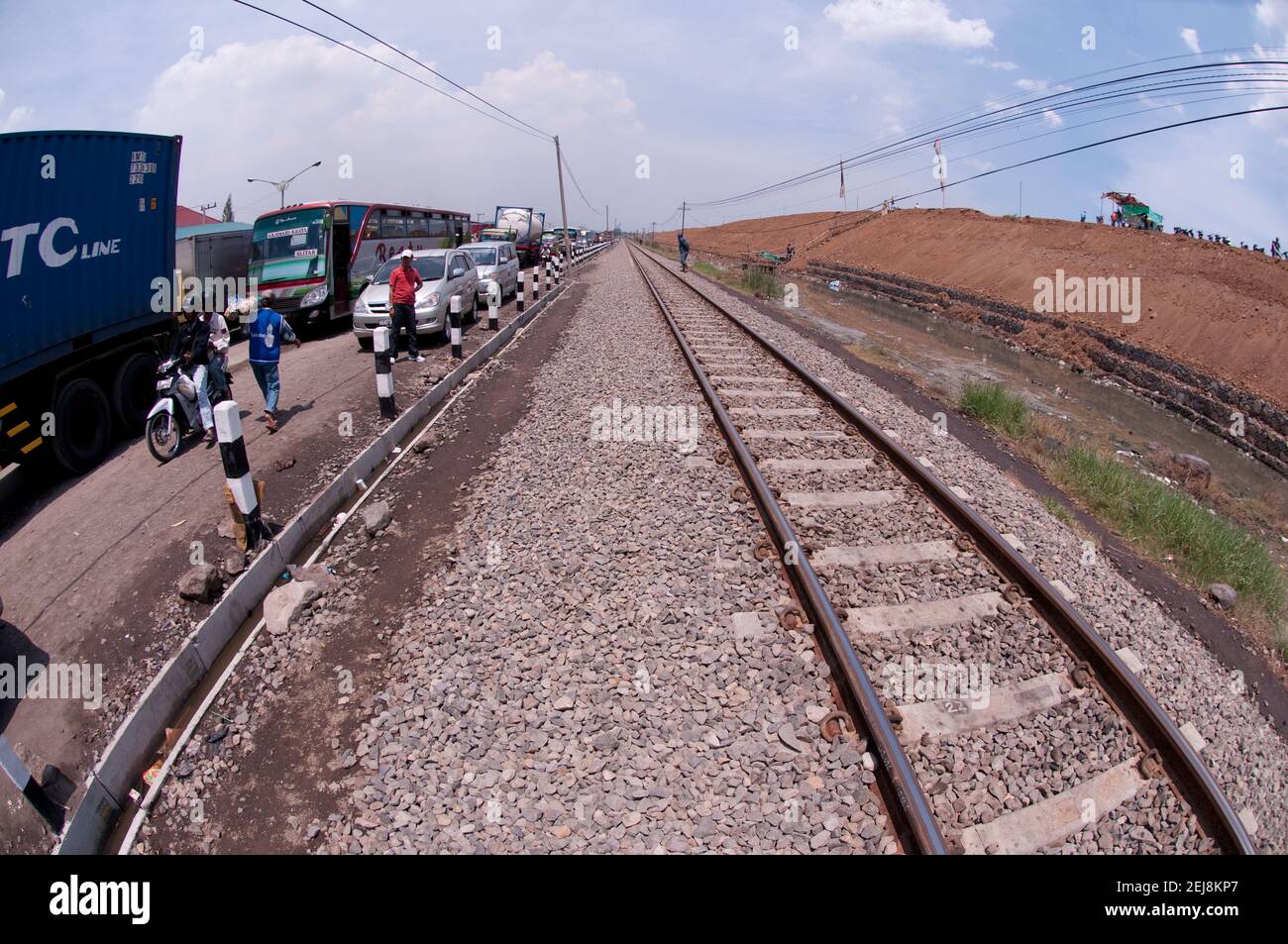 Train tracks and road by mudflow disaster levee seperating village and ...