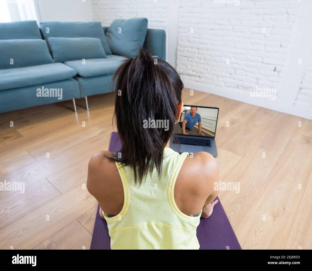 People exercising at home connected to online fitness class on laptop ...