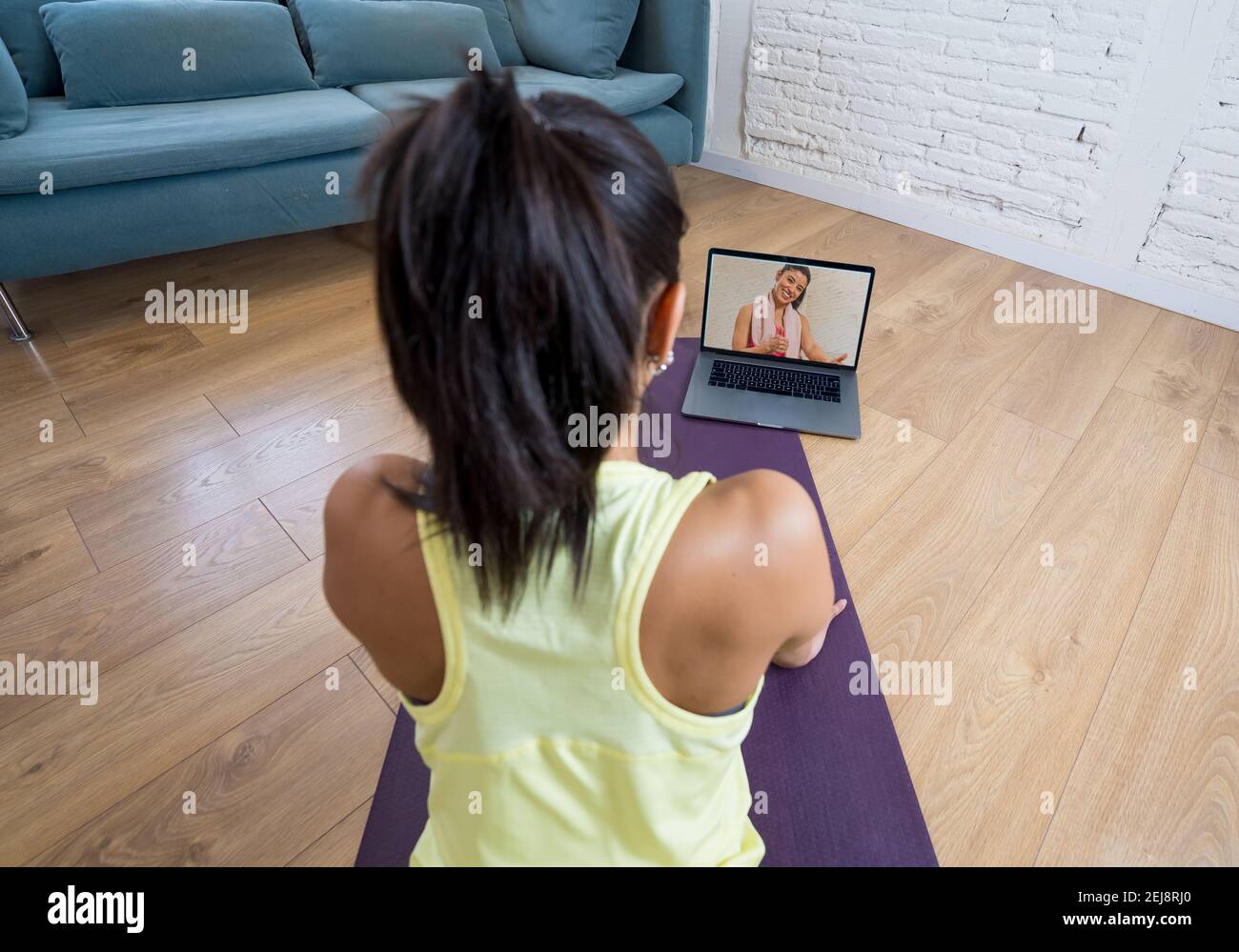 People exercising at home connected to online fitness class on laptop ...