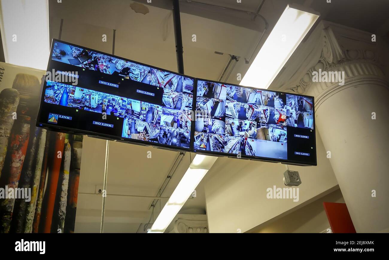 A monitor shows the video feeds from security cameras of a store in New ...