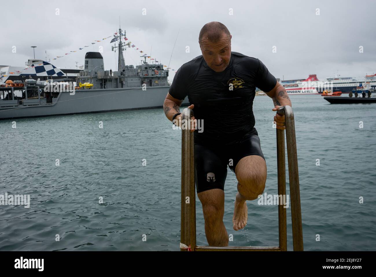 A Greek orthodox believer seen getting out of the cold water during the ...