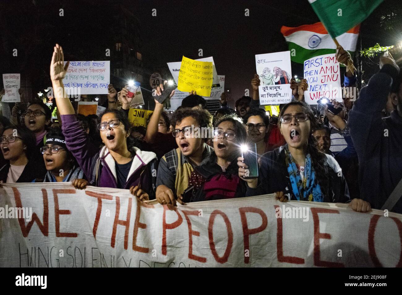 Students hold a banner and placards during the protest. Jadavpur ...