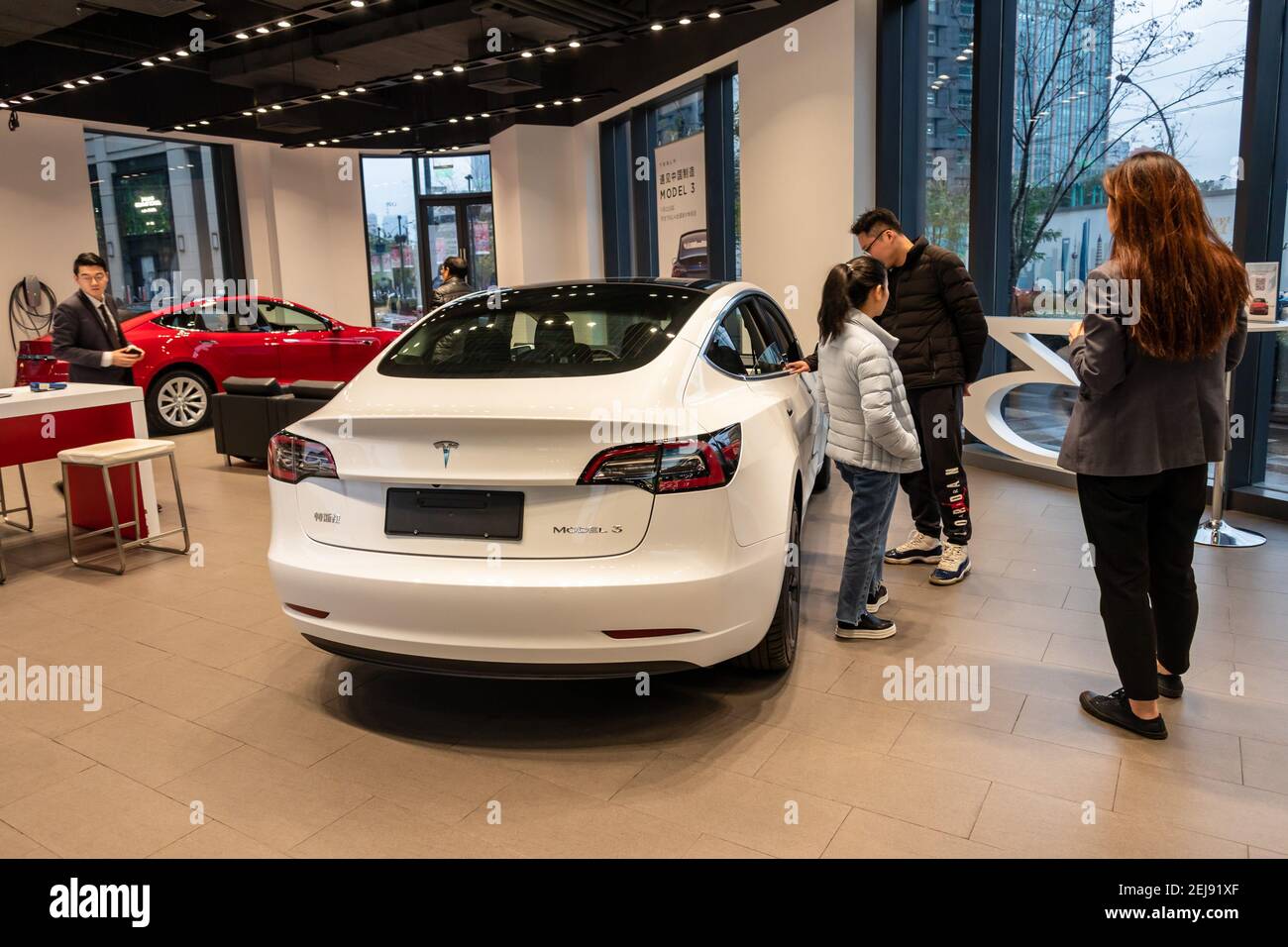 Customers view a domestically-manufactured Tesla Model 3 electric car ...