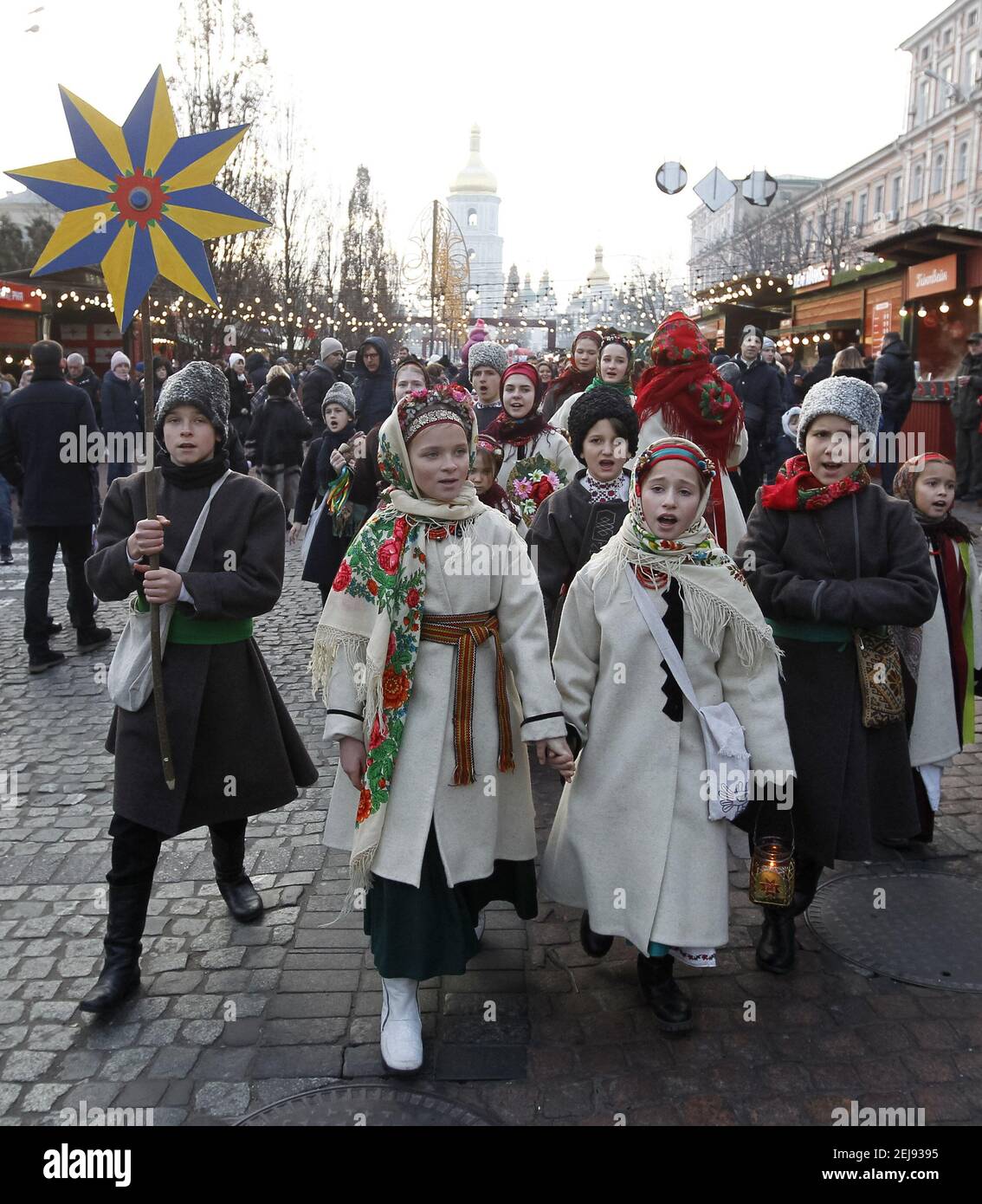 People wearing traditional clothes sing Christmas carols during the ...