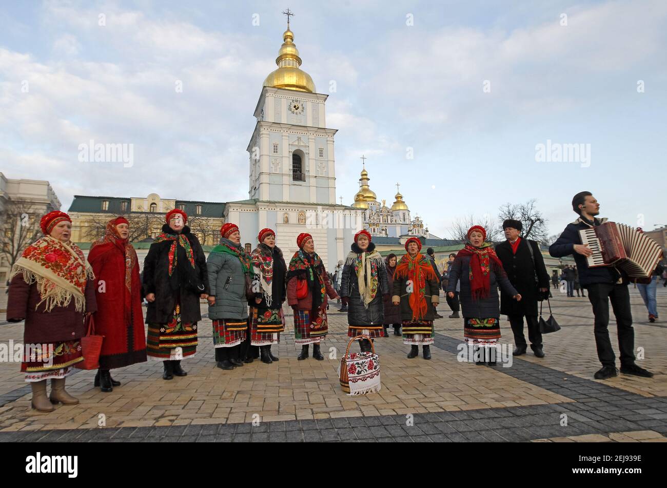 People wearing traditional clothes sing Christmas carols during the ...