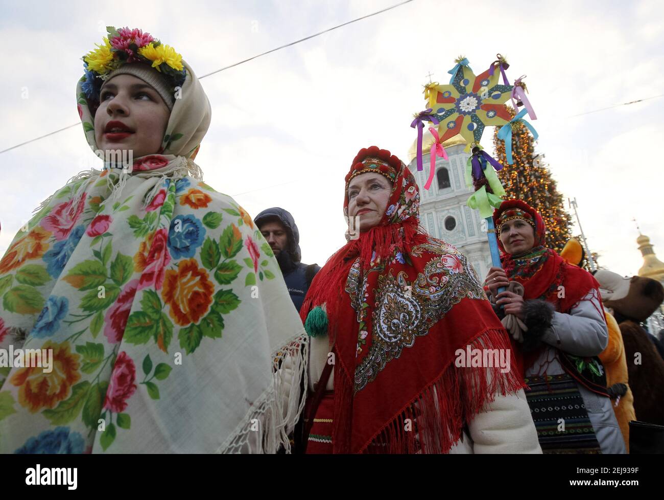 People wearing traditional clothes sing Christmas carols during the ...