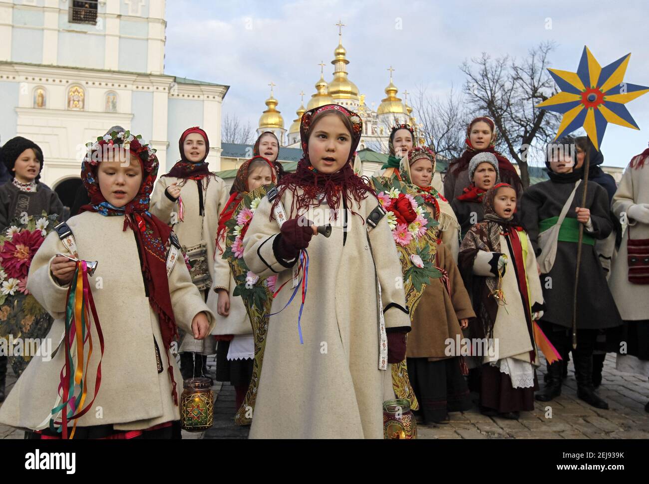 People wearing traditional clothes sing Christmas carols during the ...