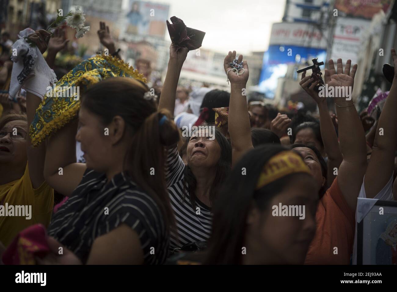 Catholic devotees react as priests sprinkle holy water on the crowd ...