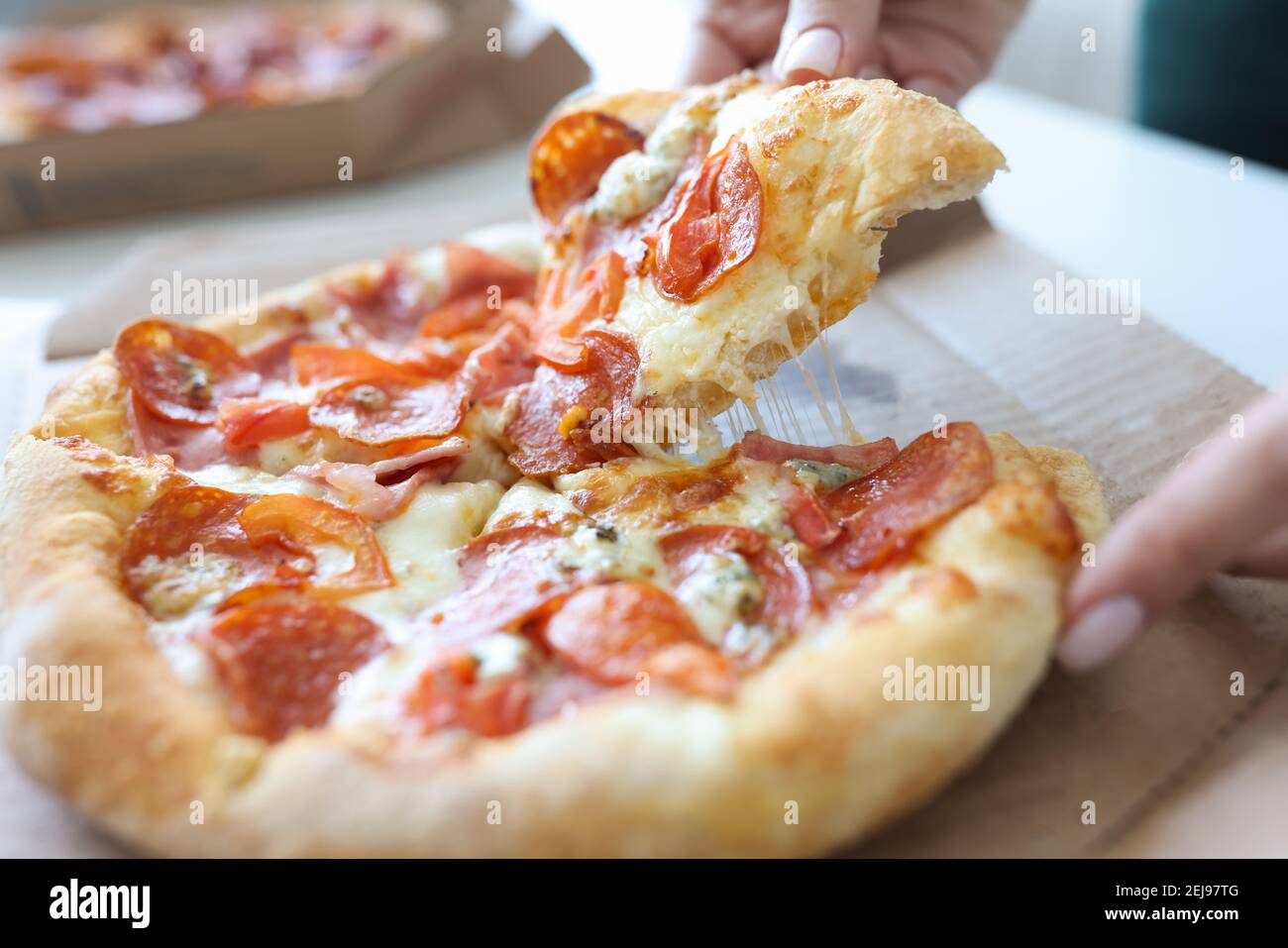 Hand taking piece of pizza hi-res stock photography and images - Alamy