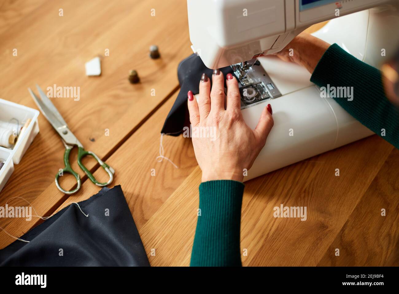 Step by step, 50-yers old woman sews clothes on sewing machine, Mature ...
