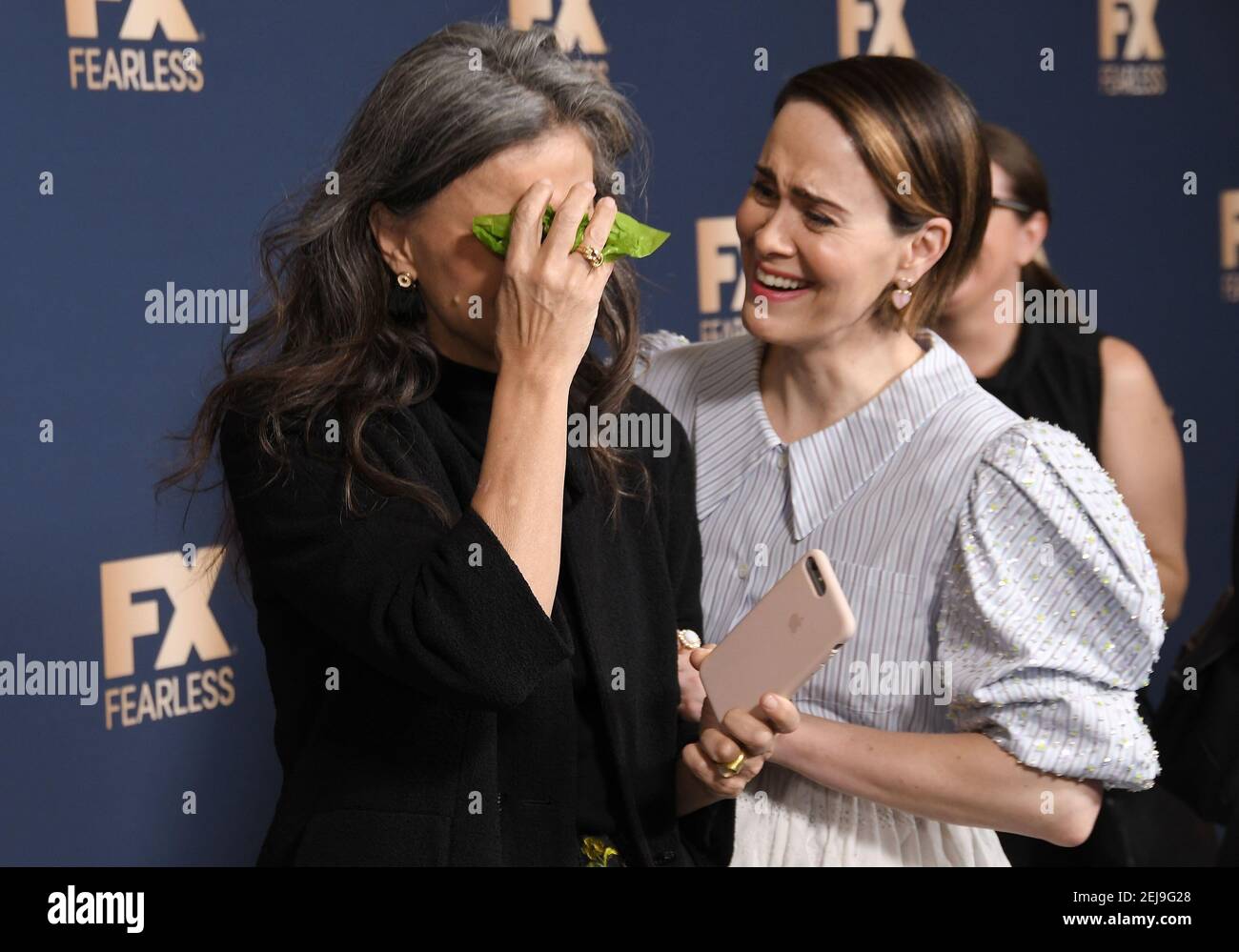 Tracey Ullman wiping her face with a doggy poop bag as Sarah Paulson ...